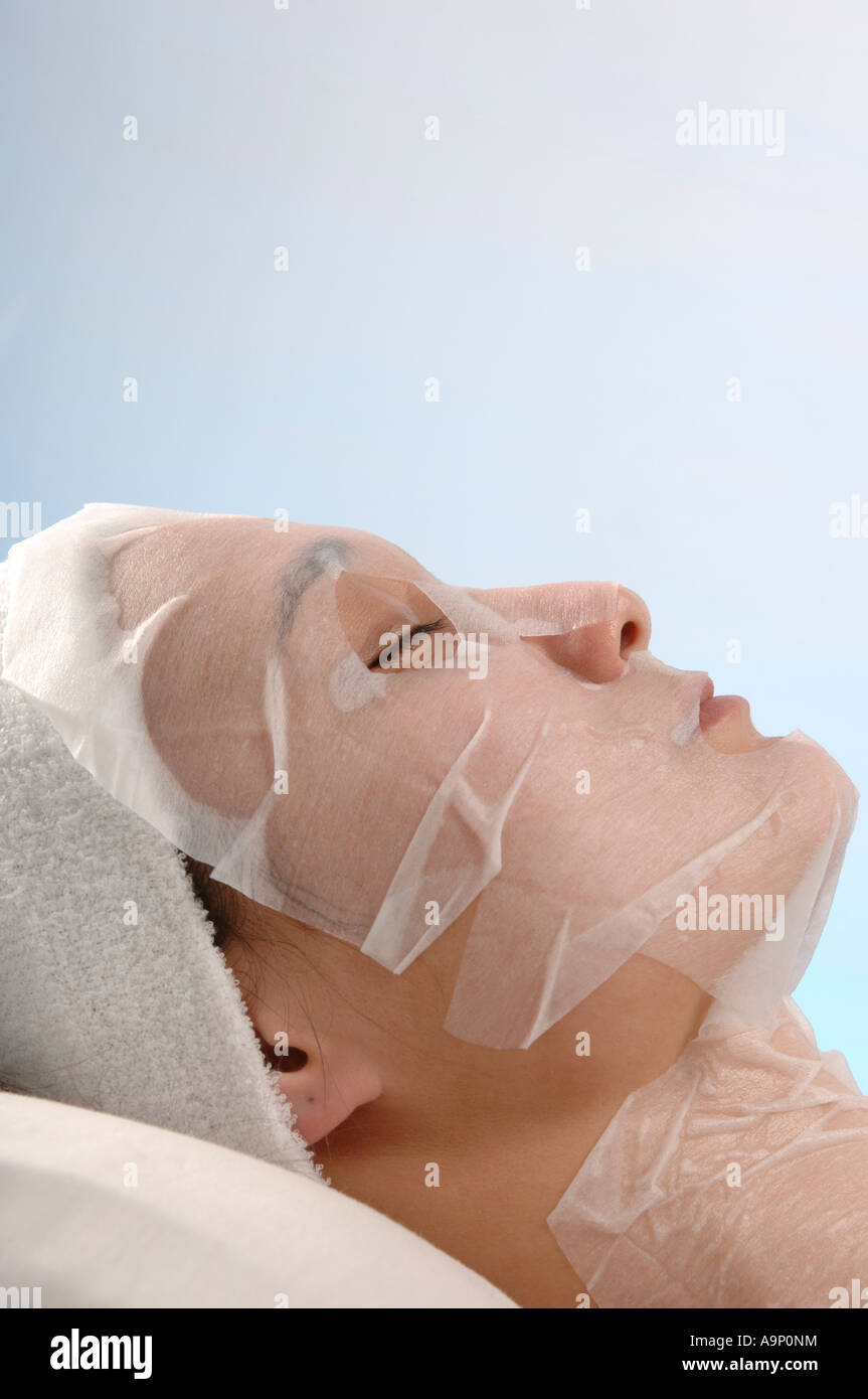 Woman relaxing with a facial mask Stock Photo - Alamy