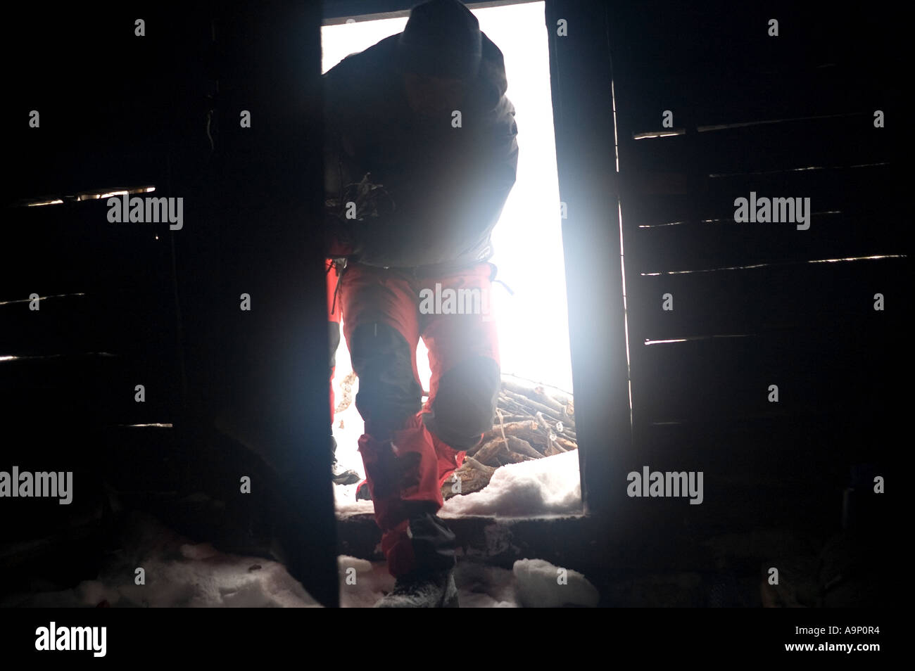 Man entering a hut Stock Photo - Alamy