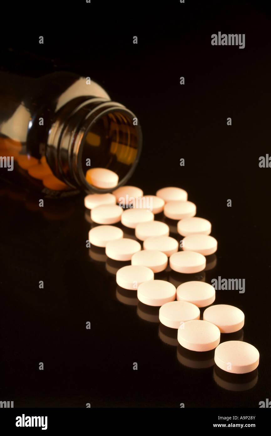 Medicine bottle with spilled pills Stock Photo - Alamy