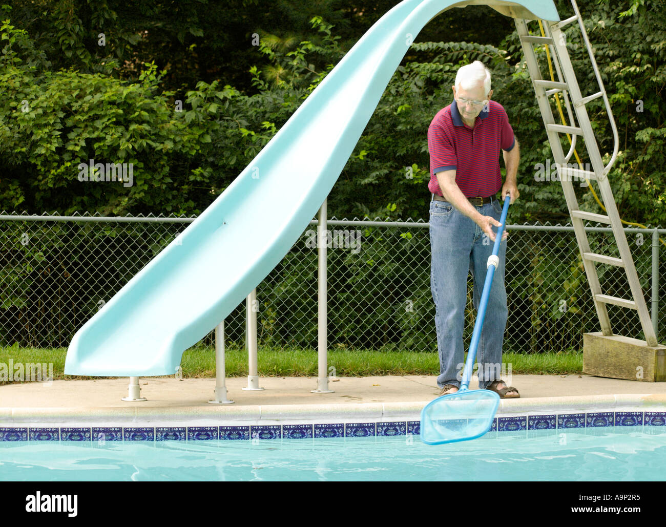 Elderly man cleaning pool with net Stock Photo - Alamy