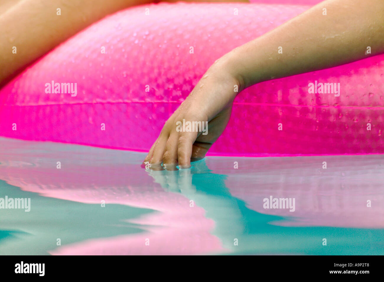 Hand of a young girl dangling in a pool Stock Photo - Alamy