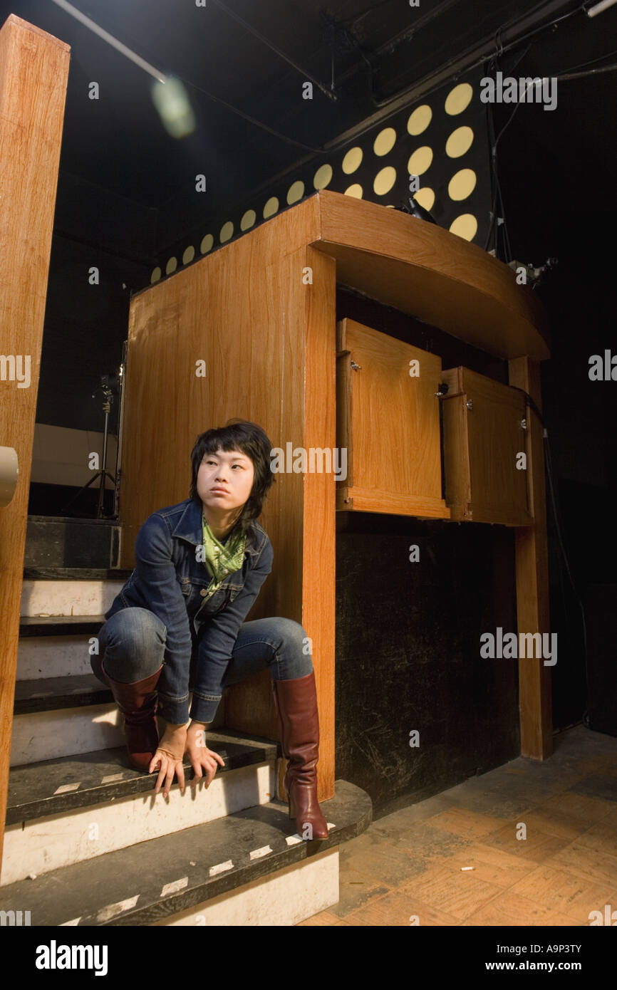 View of a young Asian woman sitting on steps Stock Photo - Alamy