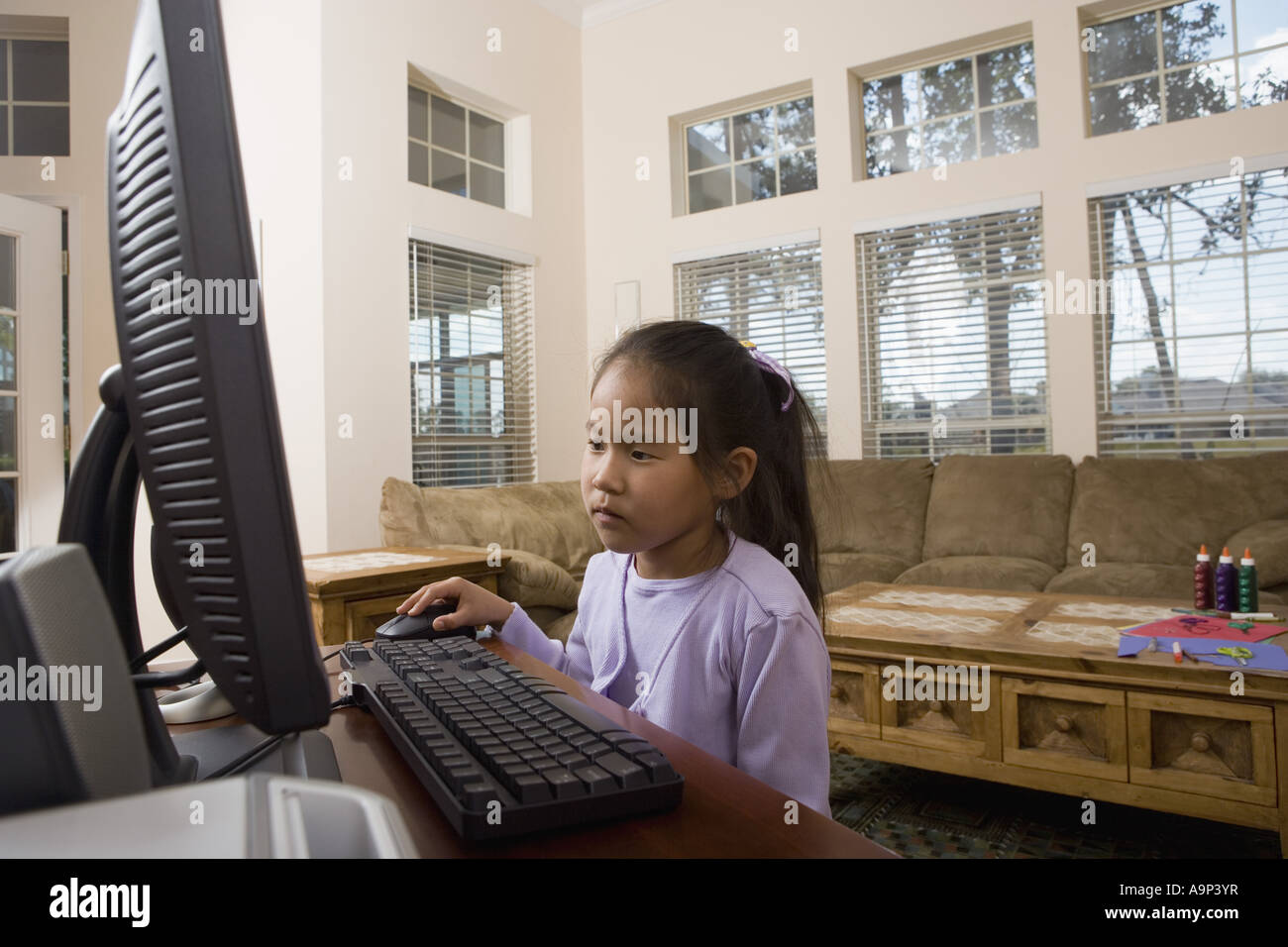 Young Asian girl using computer Stock Photo - Alamy