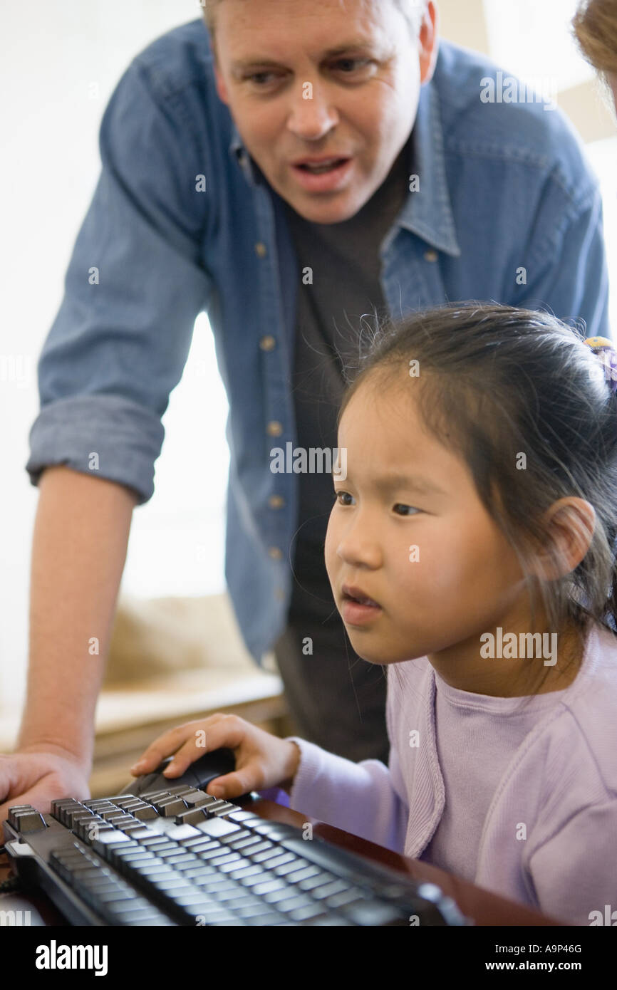 Father and daughter working on computer Stock Photo - Alamy