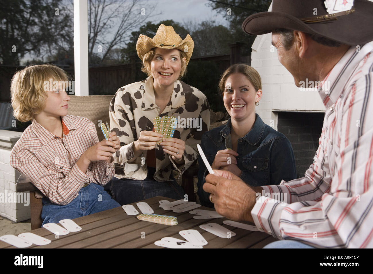 Portrait of a country family playing card game Stock Photo - Alamy