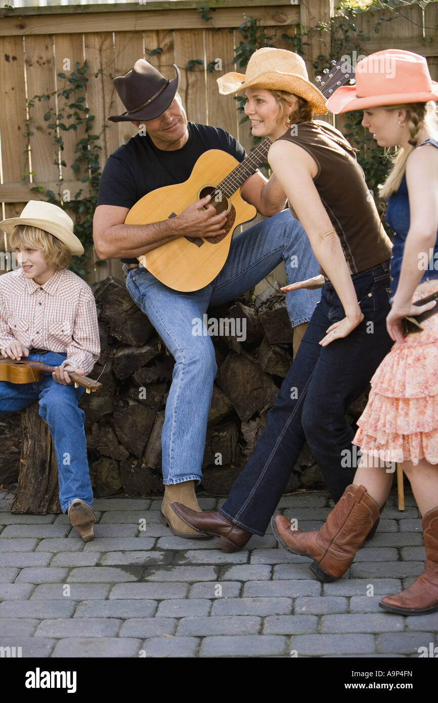 Family playing country music and dancing Stock Photo - Alamy