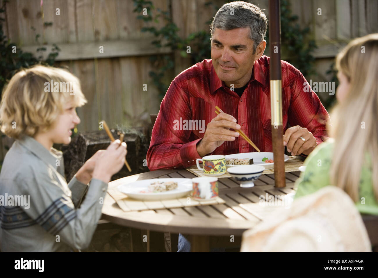 Children and father eating sushi Stock Photo - Alamy