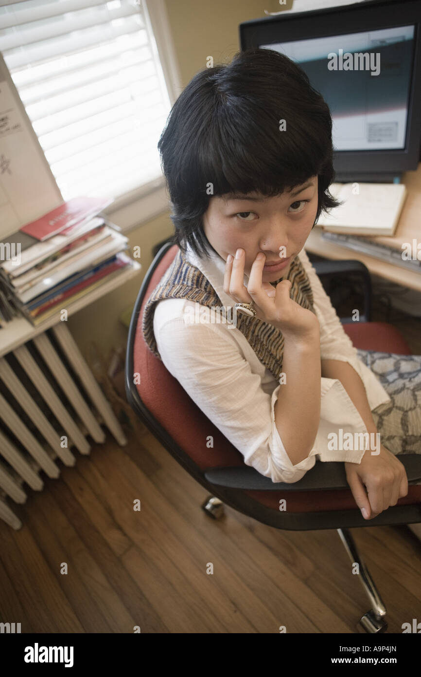 Young Asian woman working on computer at desk Stock Photo - Alamy