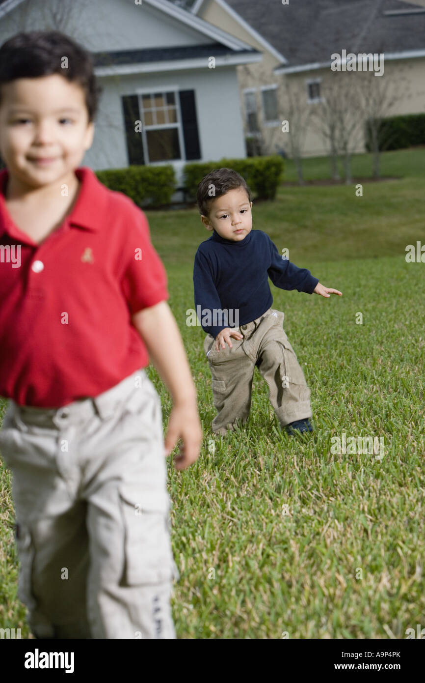 Portrait of two boys playing on lawn Stock Photo - Alamy