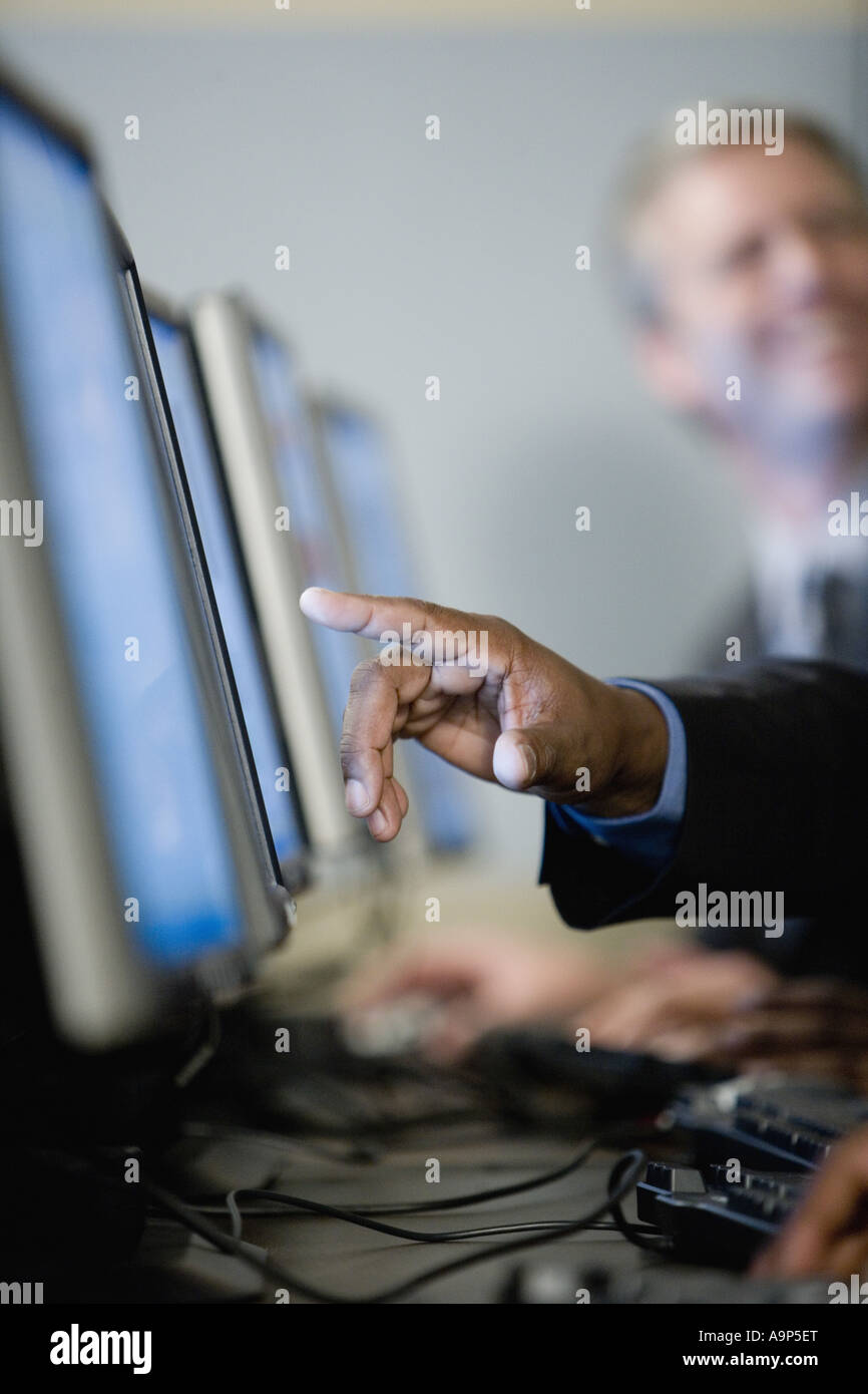 Close-up of a human hand pointing at computer screen Stock Photo - Alamy