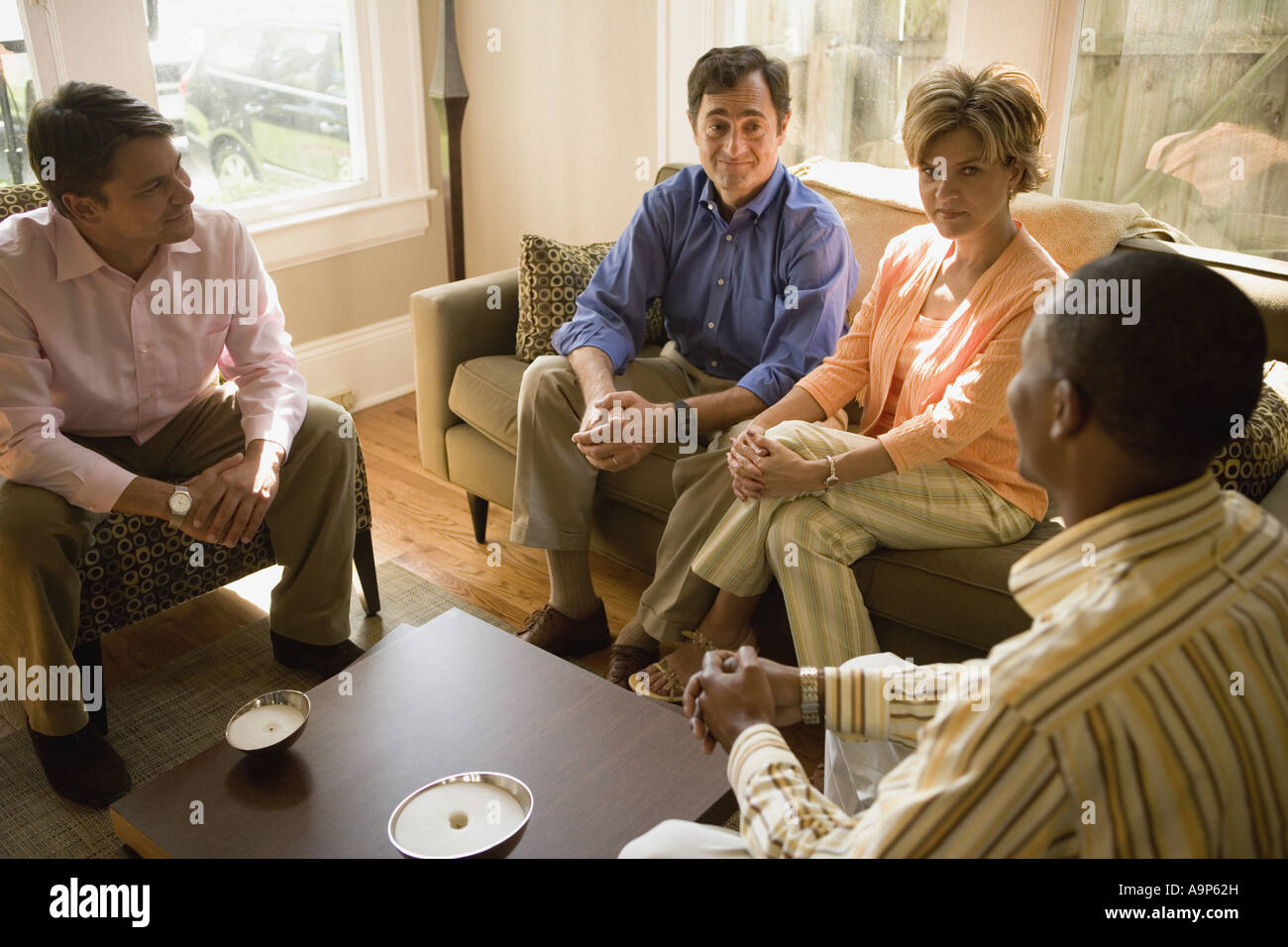 Parents chatting with adult son and friend Stock Photo - Alamy