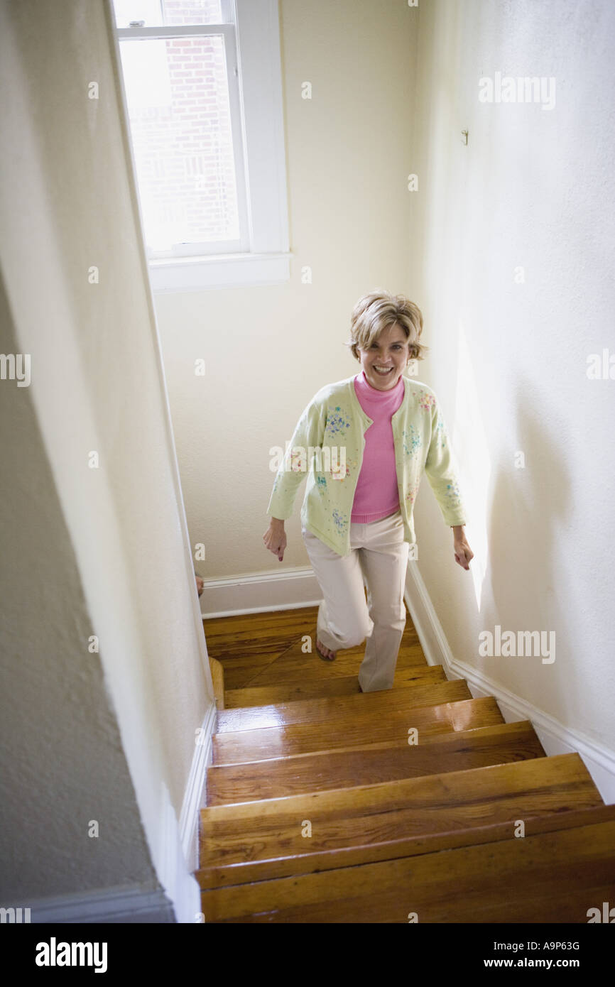 Mature woman climbing stairs Stock Photo - Alamy