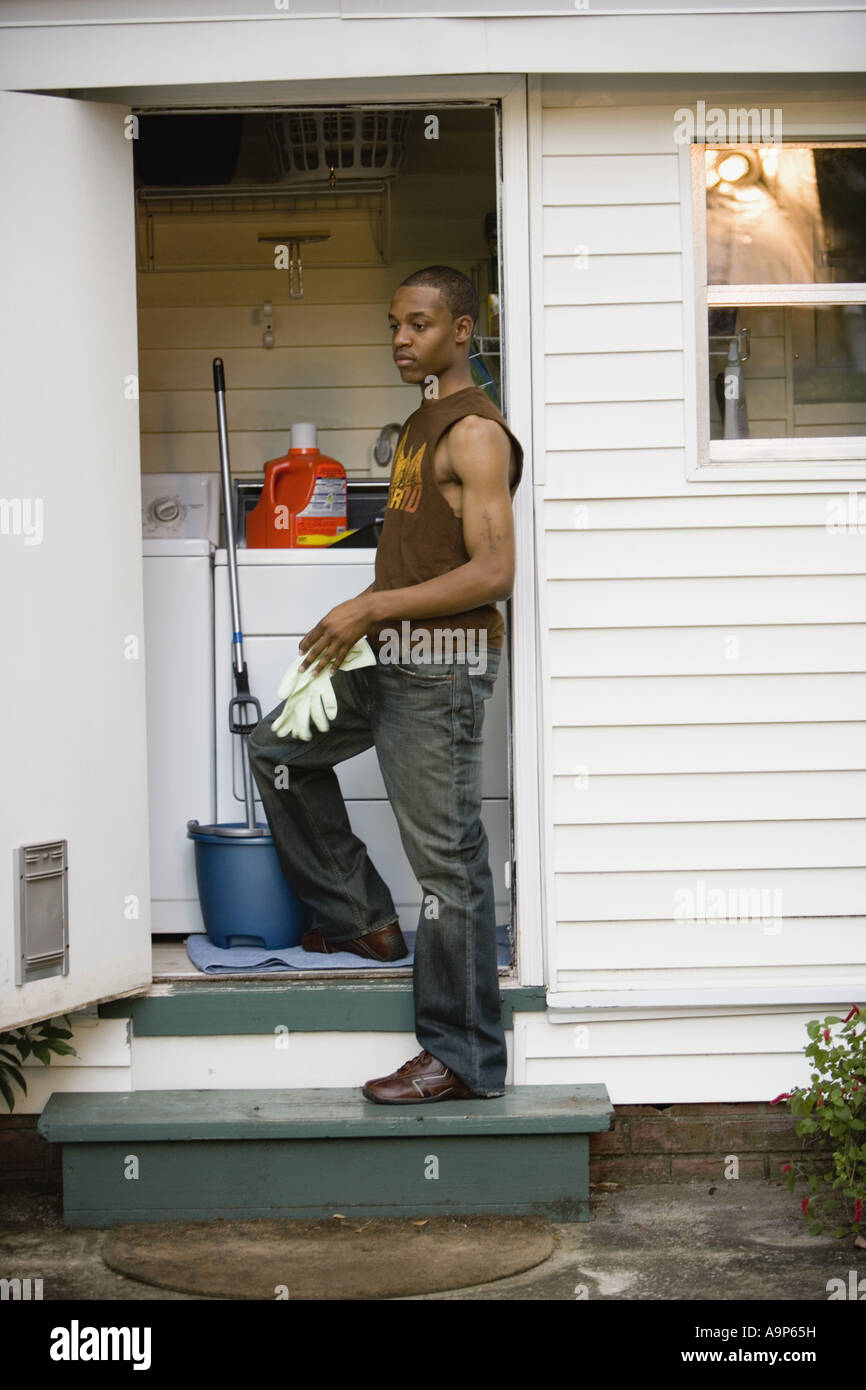 Young man doing household chores Stock Photo - Alamy
