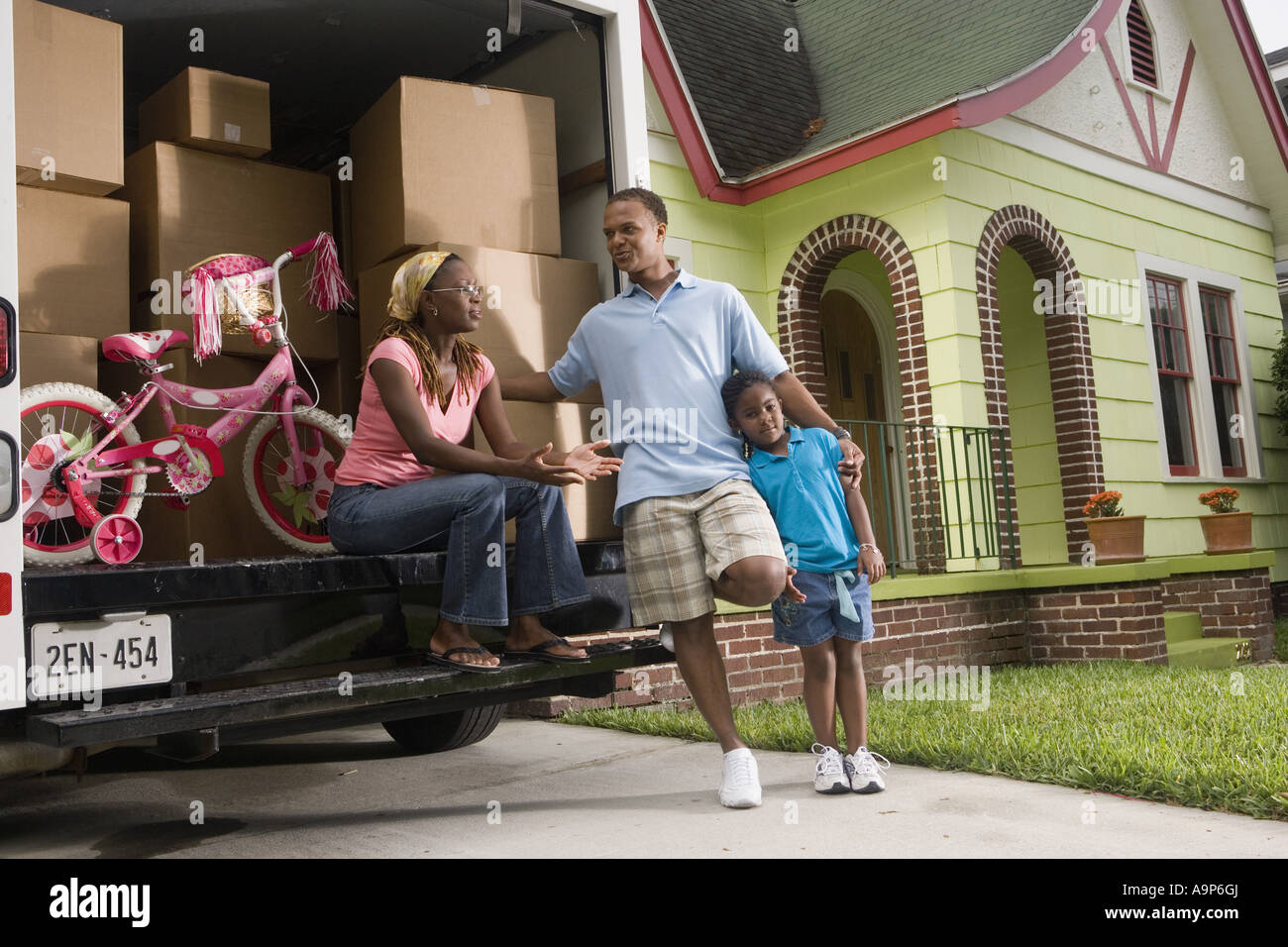 Portrait of a family standing outside a house by moving truck Stock ...