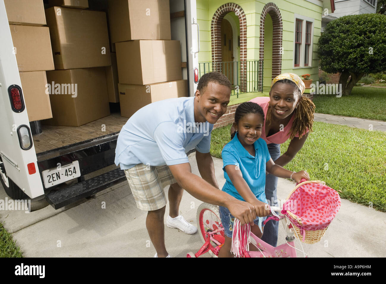 Portrait of family next to moving truck Stock Photo - Alamy