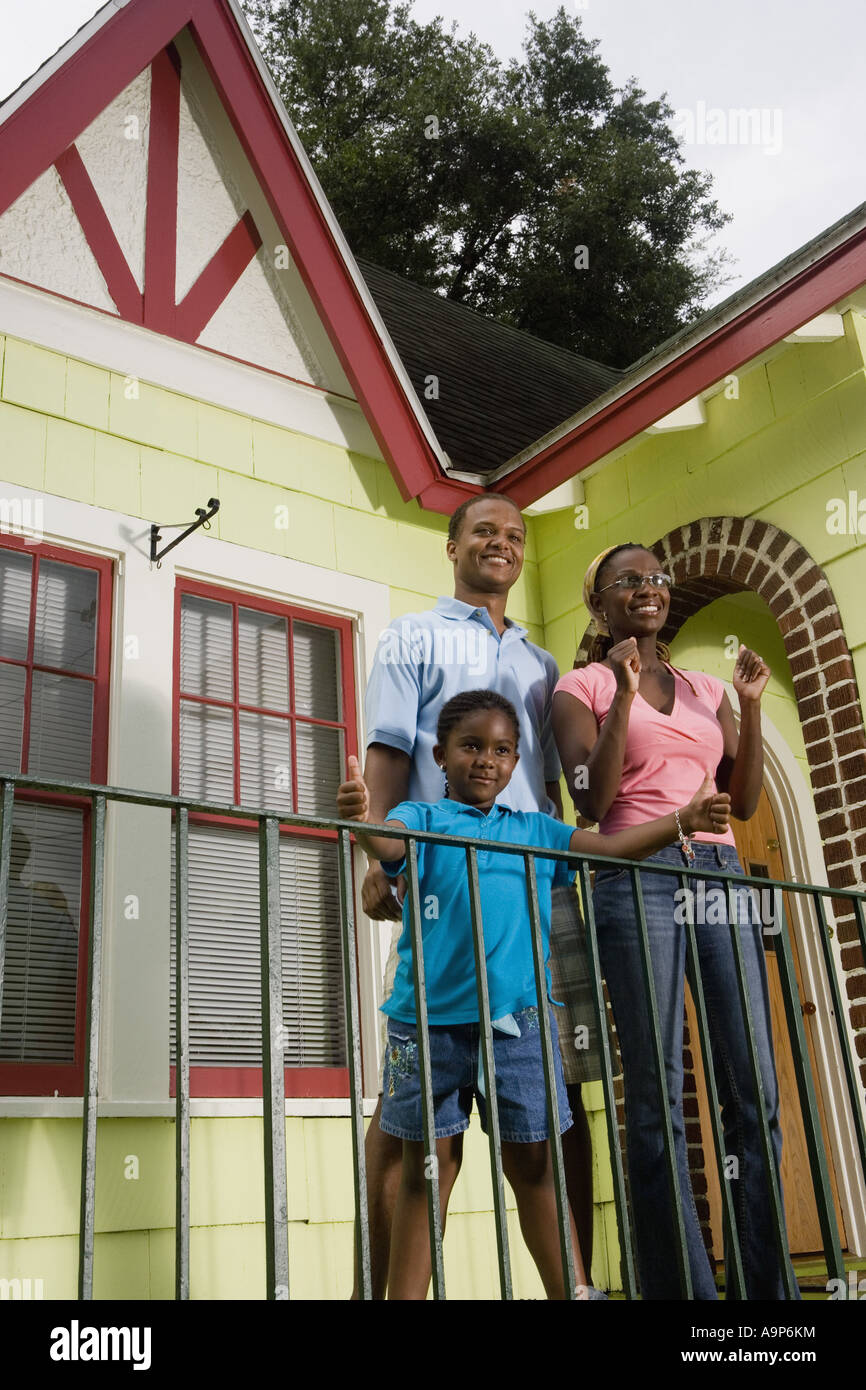Family standing outside house Stock Photo - Alamy
