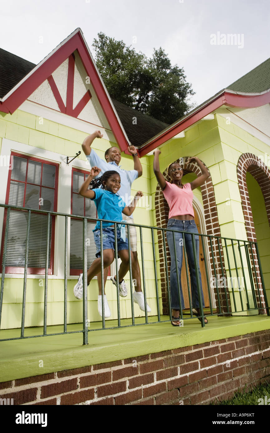 Family standing outside house Stock Photo - Alamy