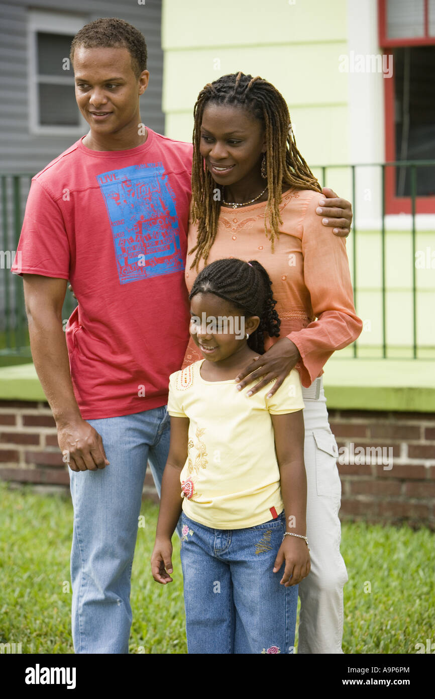 Family standing outside house Stock Photo - Alamy