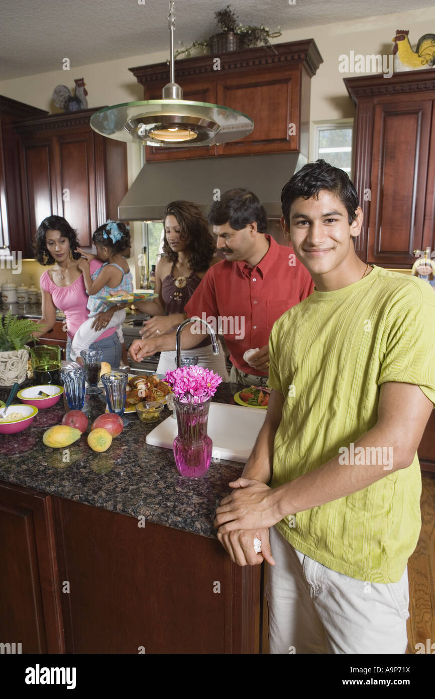 Indian family in kitchen preparing food Stock Photo - Alamy