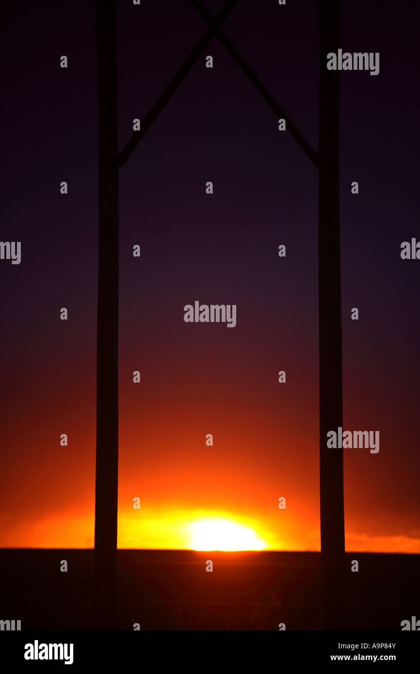 Sun setting between hydro poles in Saskatchewan Stock Photo - Alamy