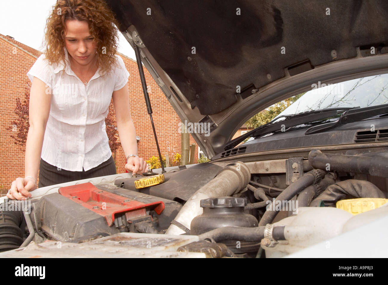 woman, looking, at, the, engine, of , her, car, a, breakdown, broken ...