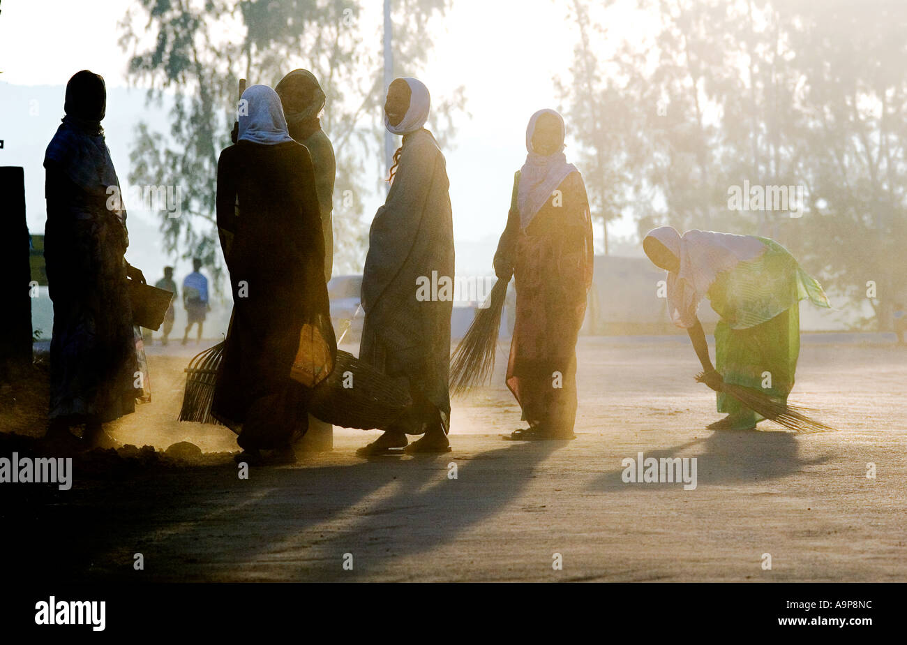 Indian street sweepers in the early morning light Stock Photo - Alamy