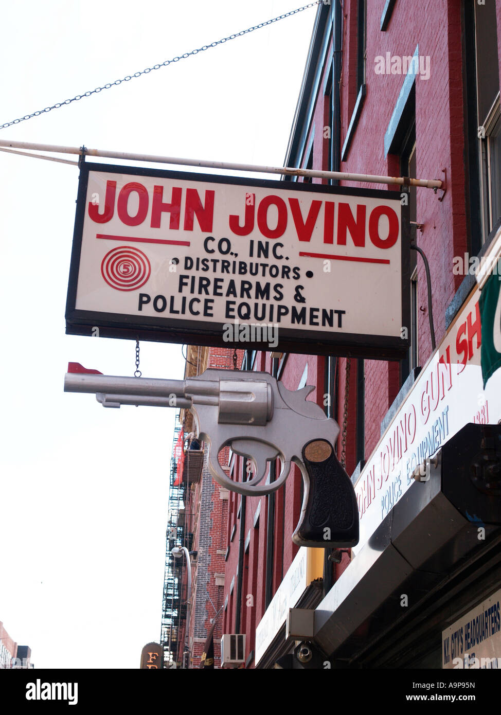 shop sign in shape of pistol outside gunstore in New York Stock Photo ...