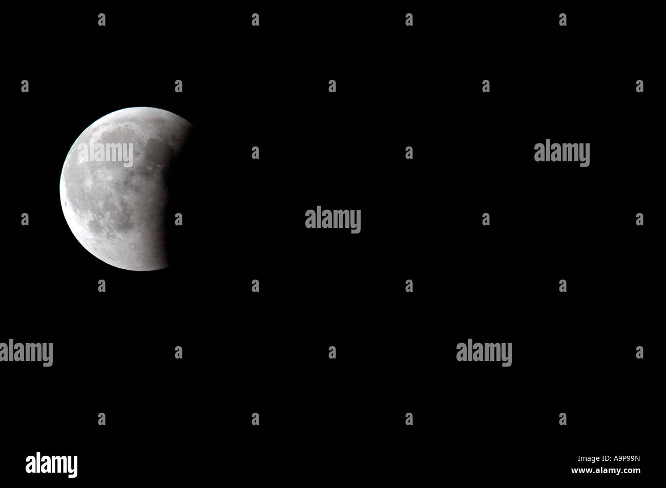 night sky showing moon coming out of total lunar eclipse phase Stock ...