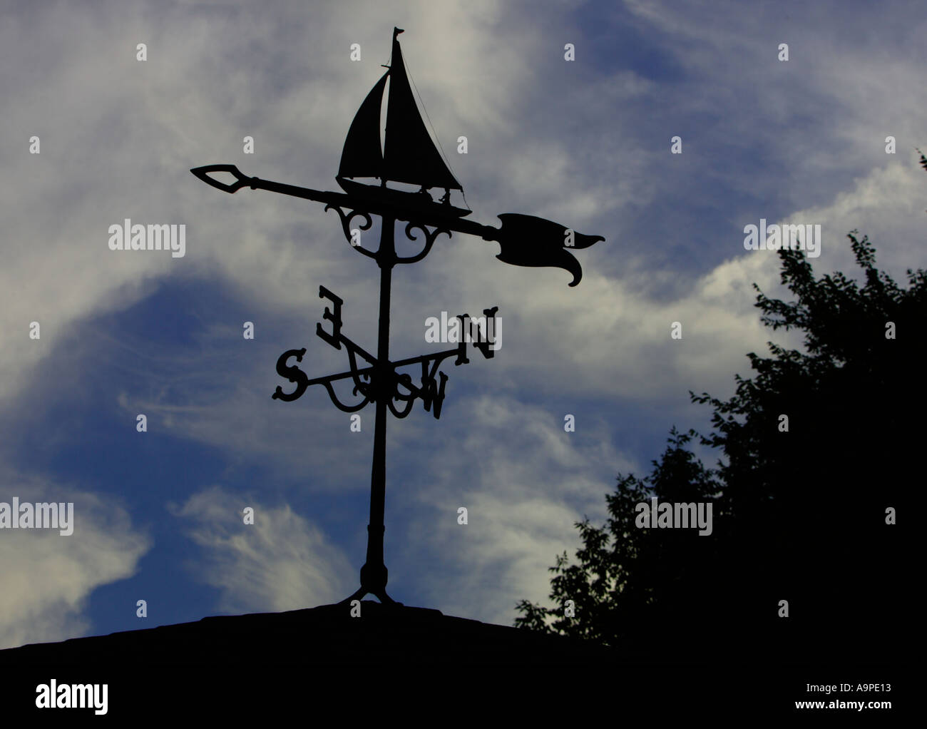 Weather vane on top of a building Stock Photo - Alamy