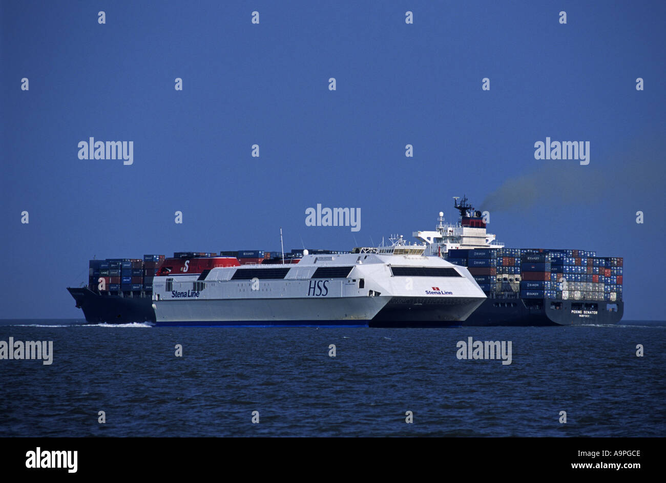 Stena Line HSS Discovery passenger ferry passing a container ship in ...