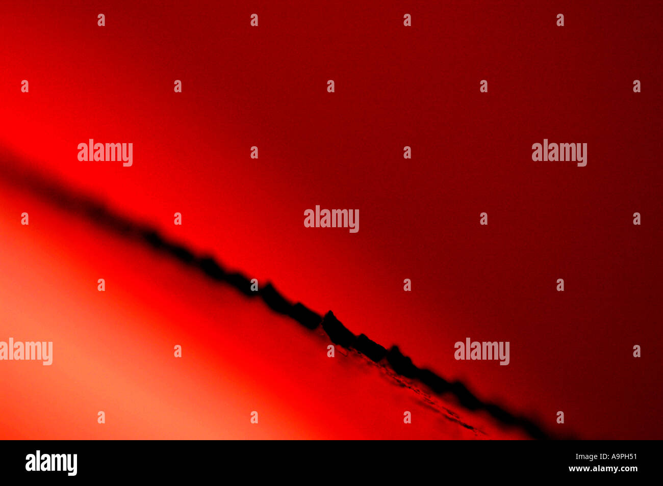 saw blade on red background Stock Photo - Alamy