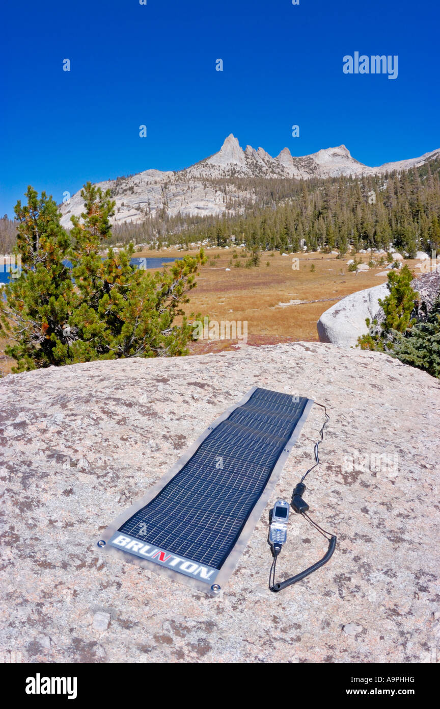 Solar panel charging a cell phone on a boulder Echo Lake Yosemite ...