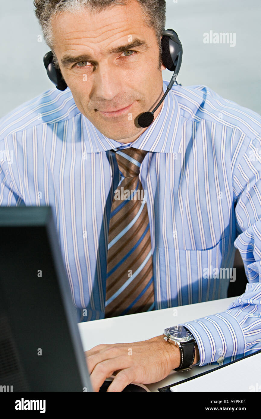 Man wearing telephone headset Stock Photo - Alamy