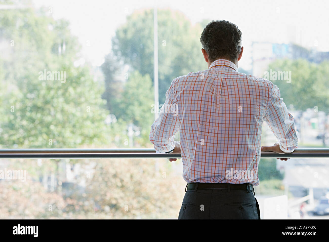 Man looking out of the window Stock Photo - Alamy