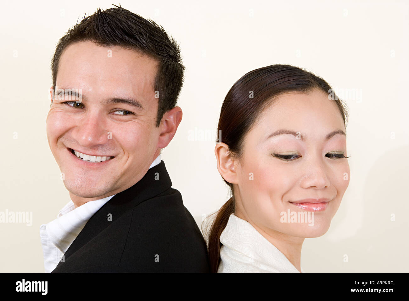 Office workers back to back Stock Photo - Alamy