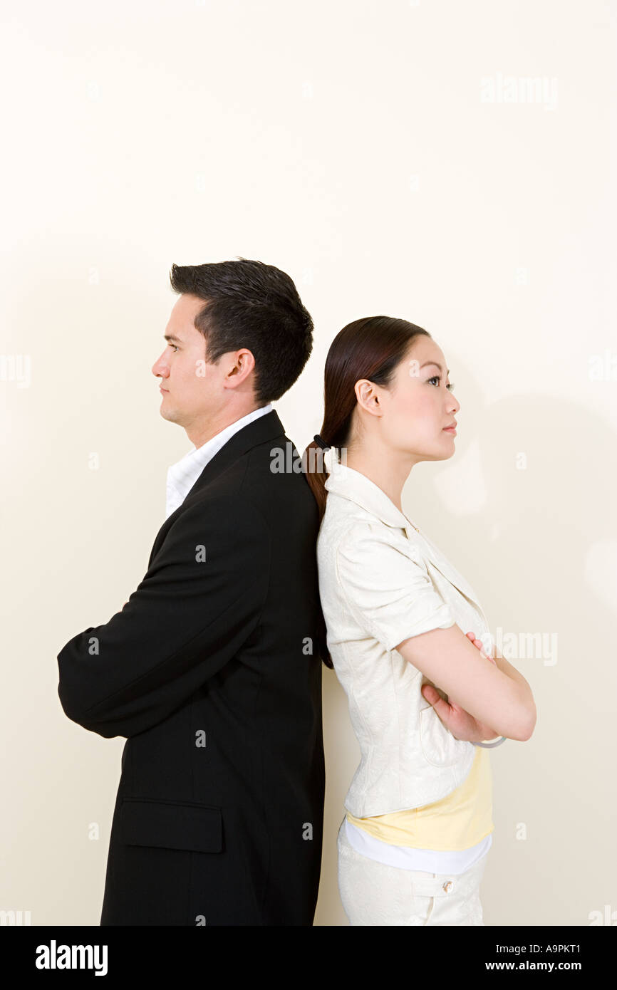 Office workers back to back Stock Photo - Alamy