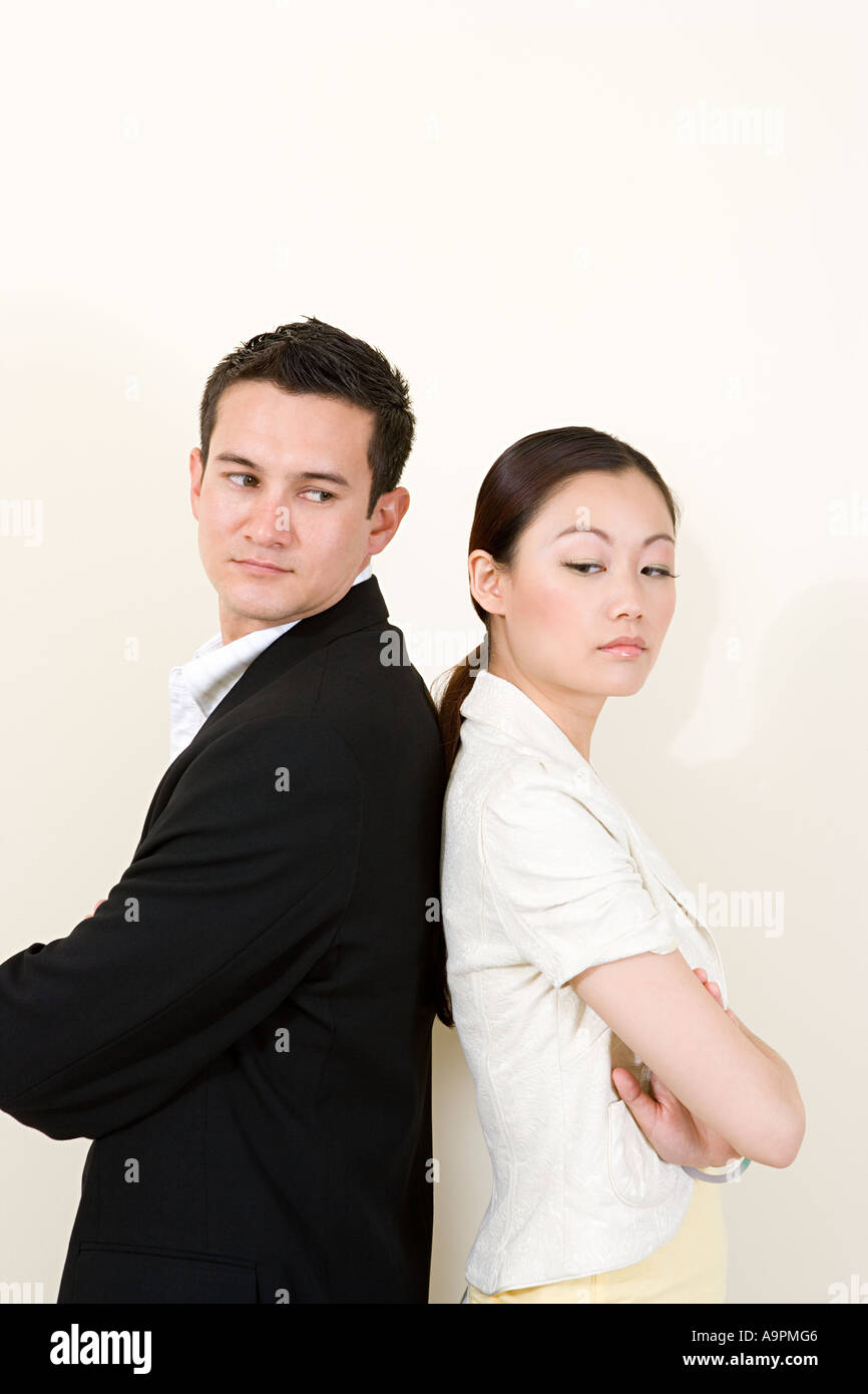 Office workers back to back Stock Photo - Alamy