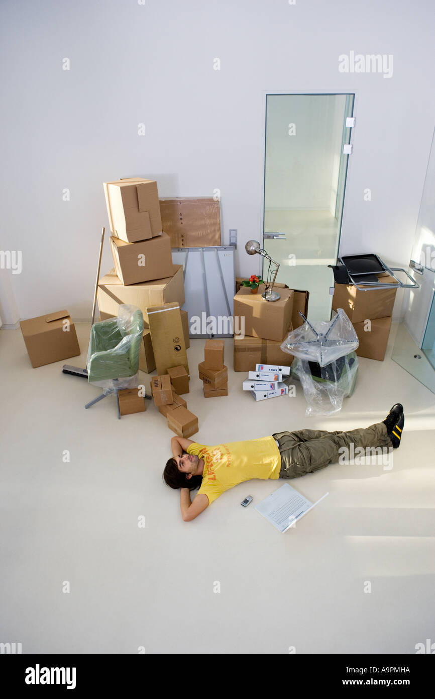 Man lying on floor of new office Stock Photo - Alamy