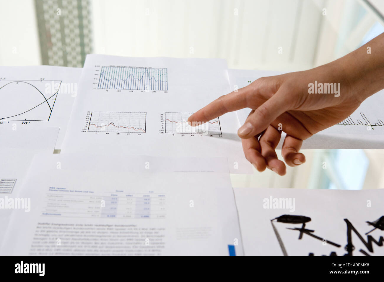 Woman pointing to graph Stock Photo - Alamy
