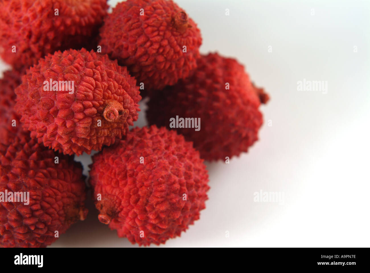 Red lichees on white background Stock Photo - Alamy