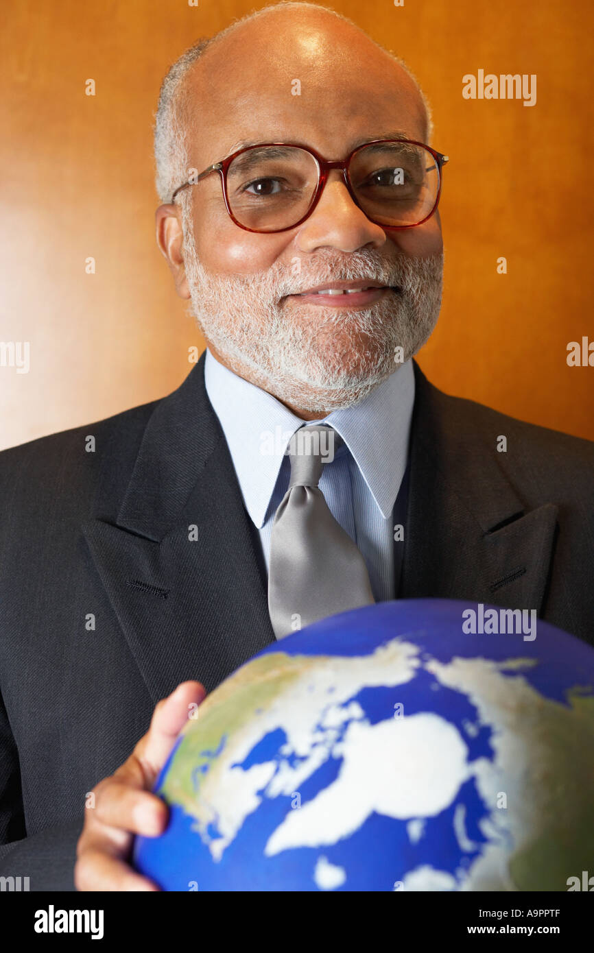 Ceo holding a globe Stock Photo - Alamy