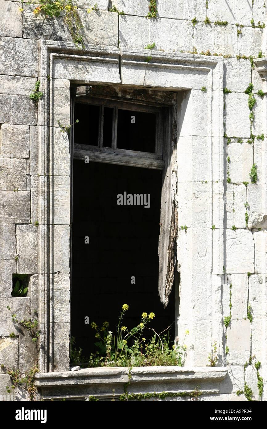 Broken empty window in dilapidated stone wall Stock Photo - Alamy