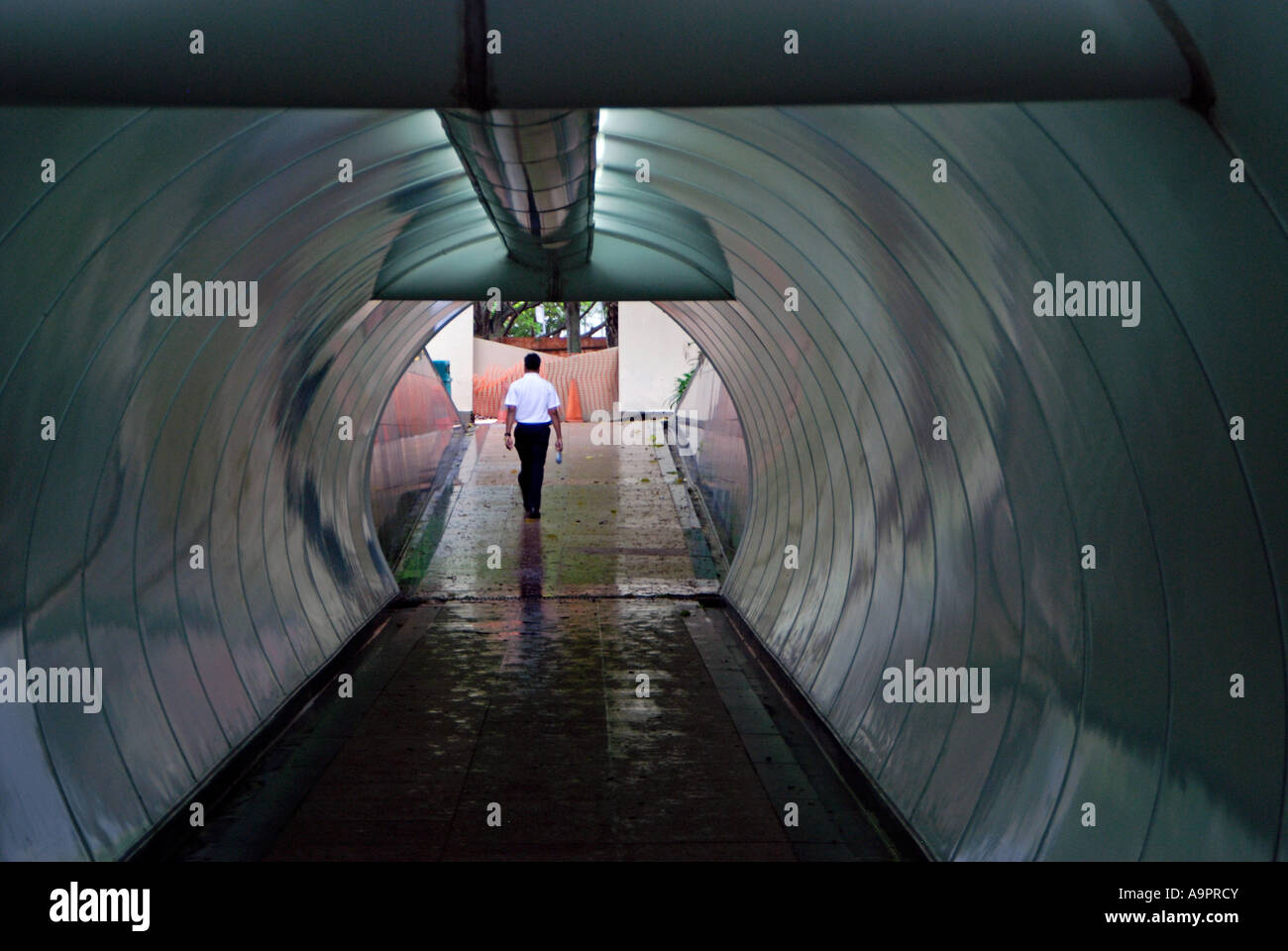 Businessman walking through pedestrian tunnel, Singapore Stock Photo ...