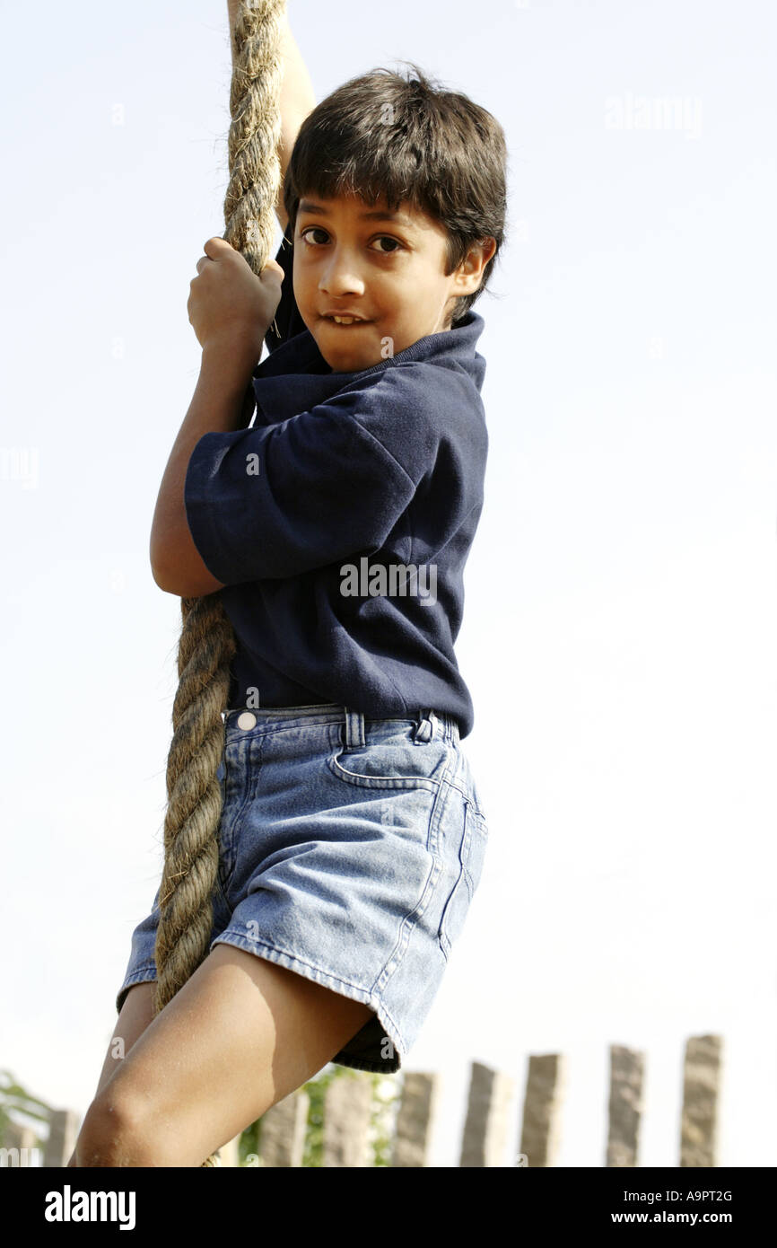 A young kid hanging from a rope Stock Photo - Alamy