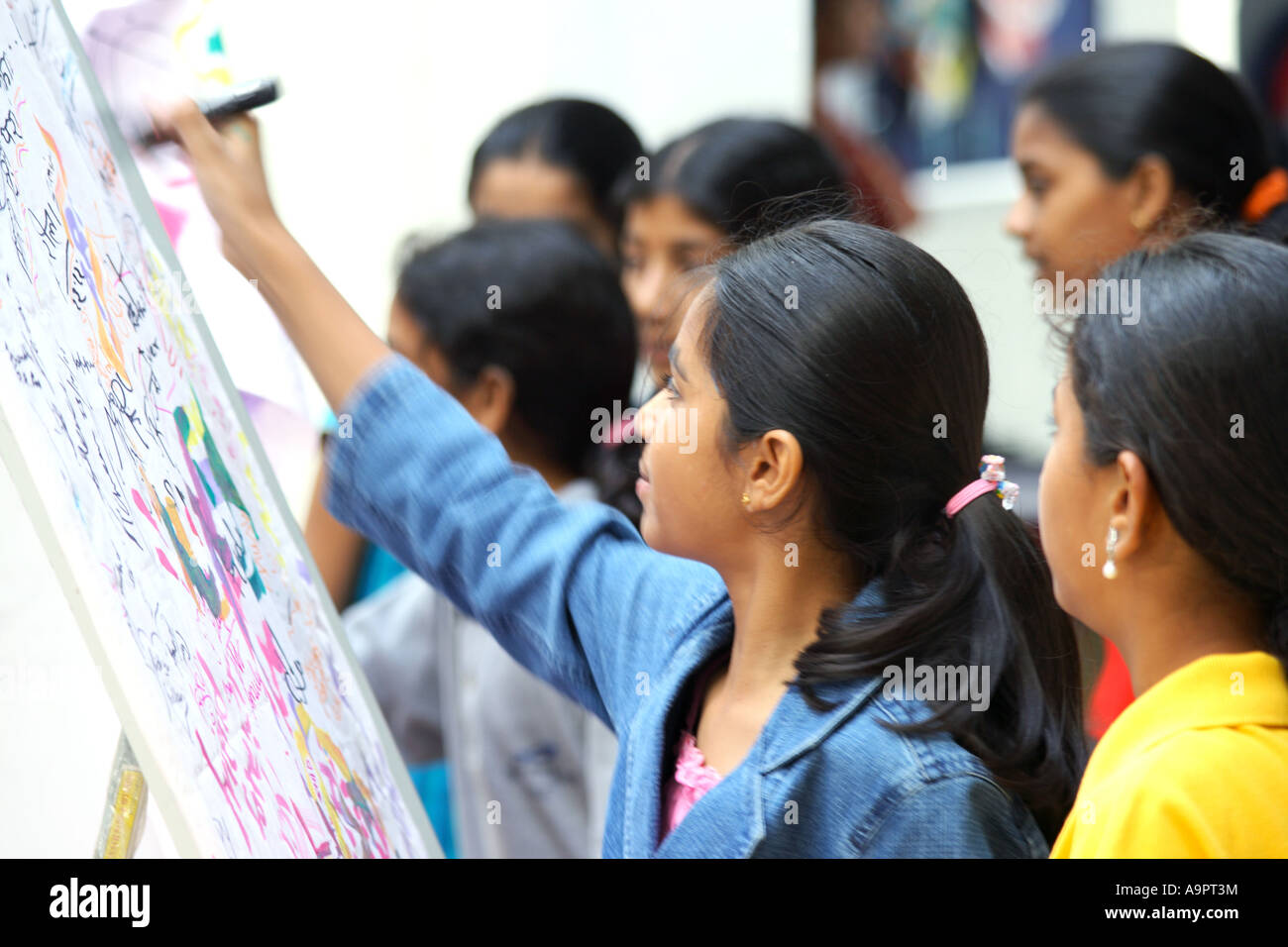 A girl writing on a board Stock Photo - Alamy