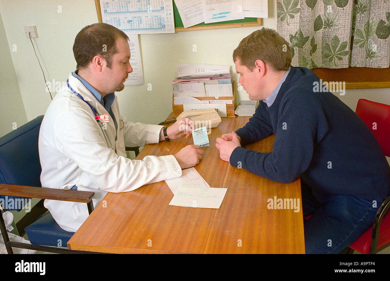Doctor in consultation with patient steroid treatment prescription card ...