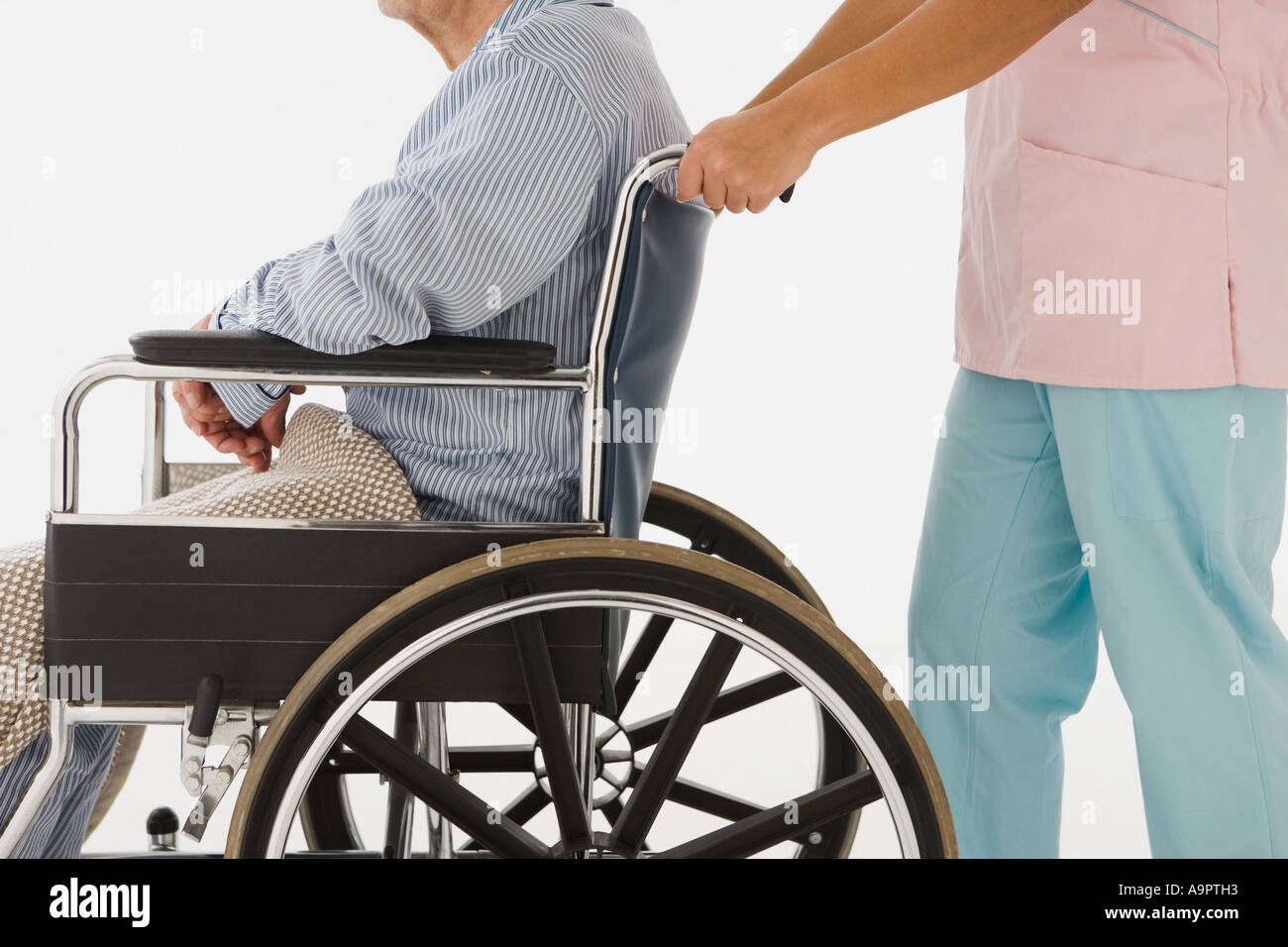 Nurse pushing man in wheelchair Stock Photo - Alamy