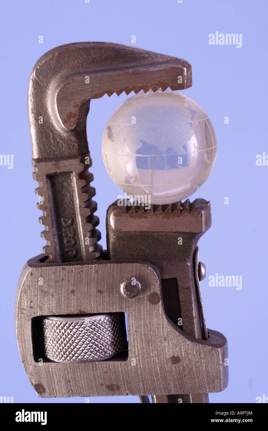 A globe held by a wrench Stock Photo - Alamy