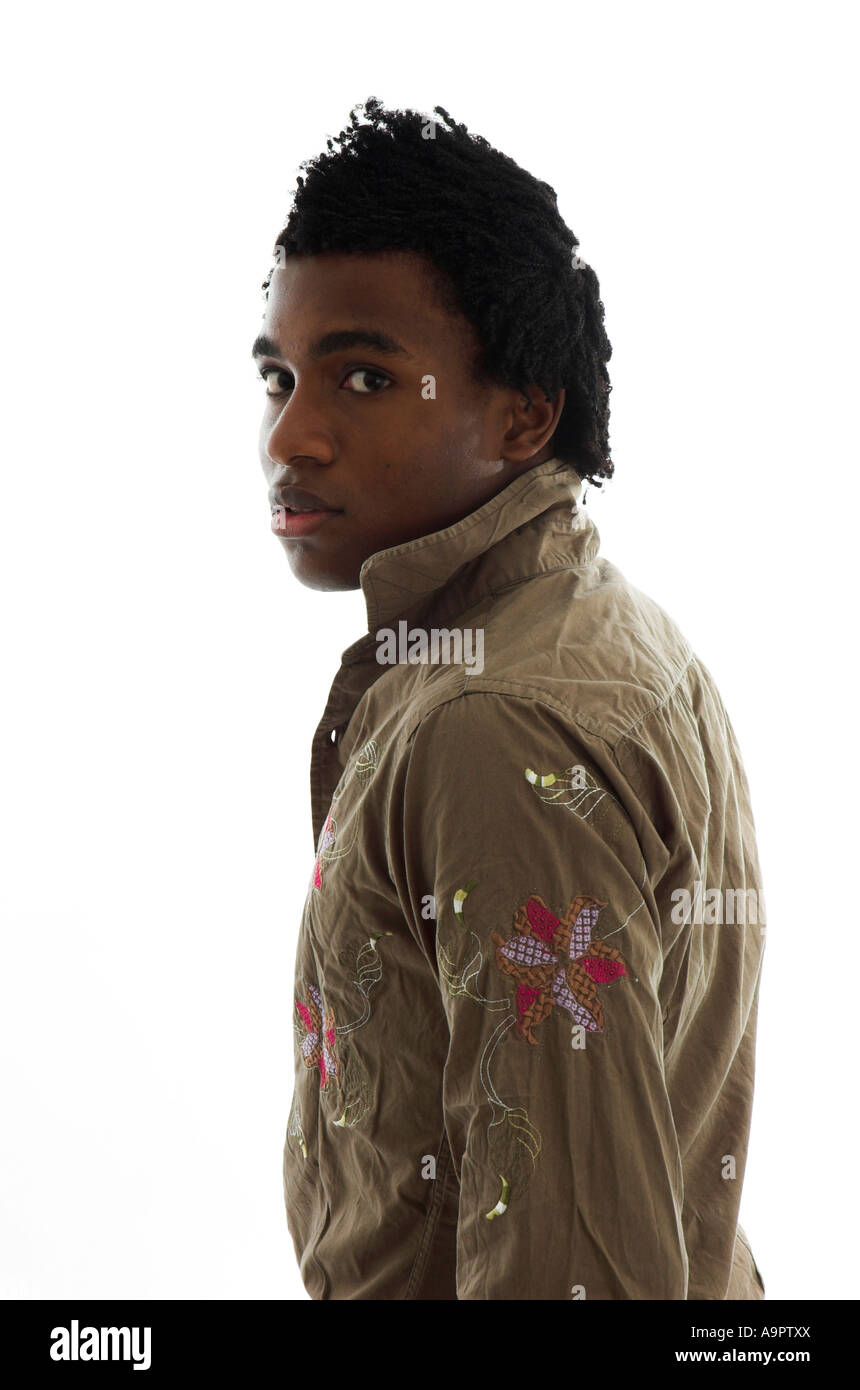 Studio shot of attractive fashionable young black man looking back over ...