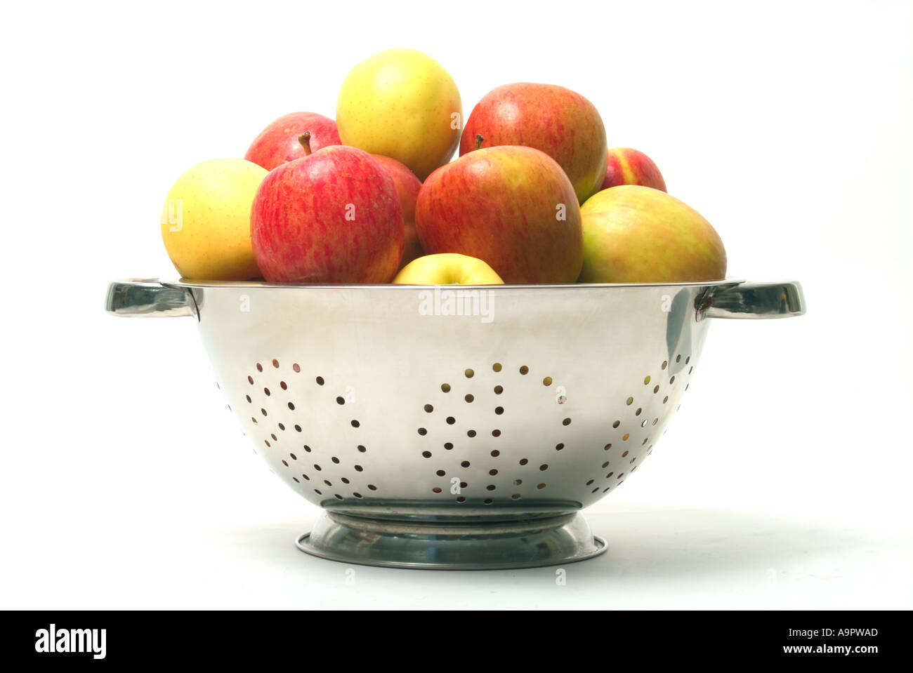 Stainless steel colander filled with ripe apples Stock Photo - Alamy